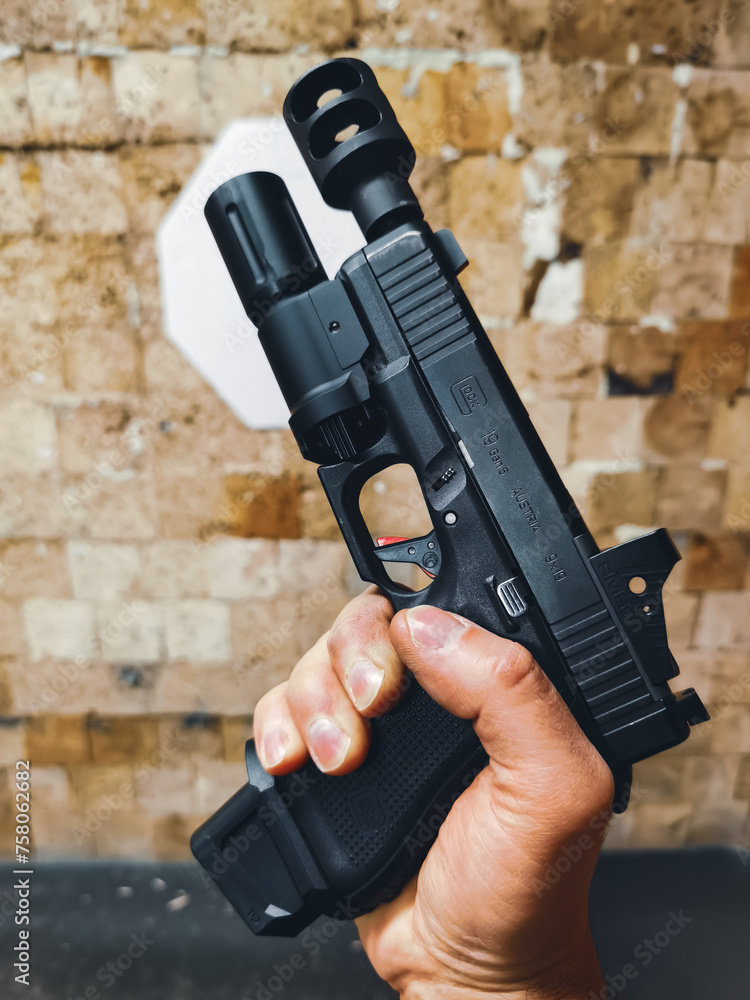 Stock-Foto „Baltic States, March 14, 2024. Glock 19 pistol with a red ...