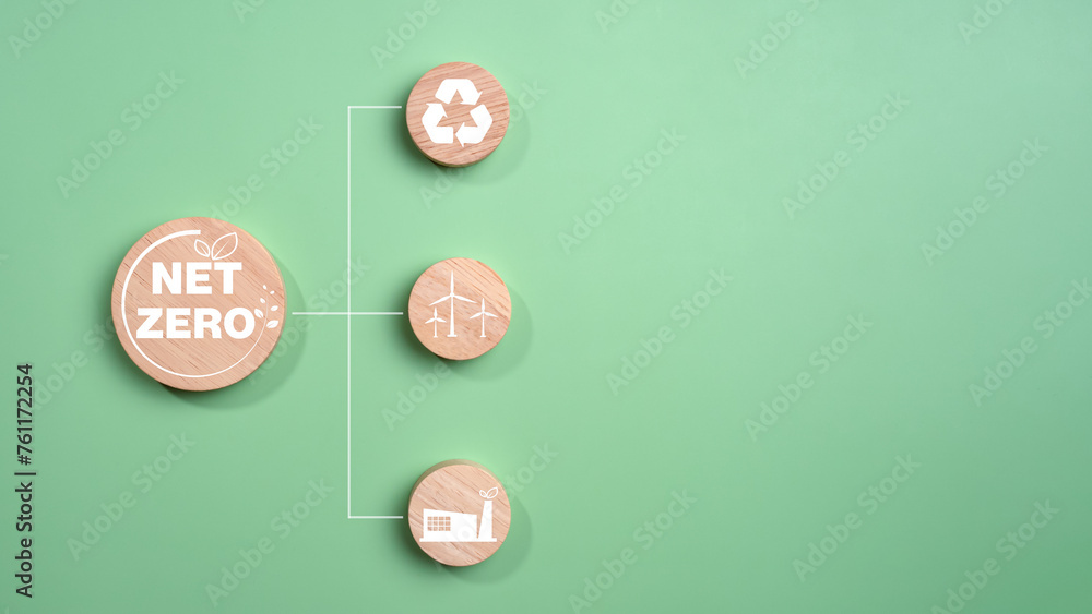Circular wooden board with net zero icon in 2050 on green background ...
