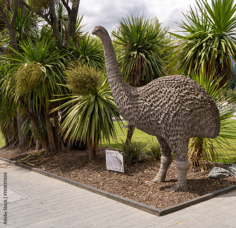 Life-size Moa bird carved effect concrete statue amidst lush greenery ...