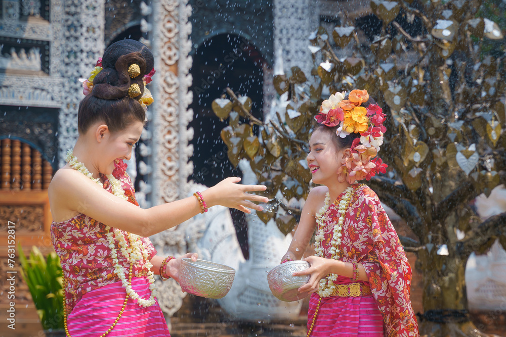 Songkran festival . Pretty Asian women playing with water-splashing Songkran. Beautiful Thai ...