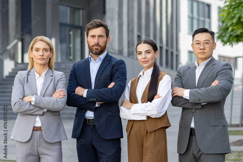 Four professional business individuals posing confidently outdoors ...