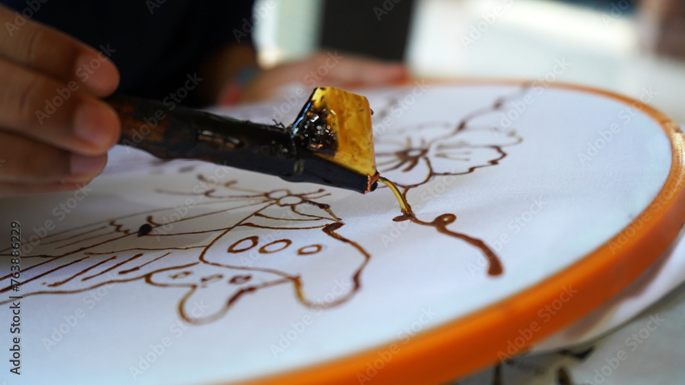 Batik making process, a handmade traditional art from Indonesia. Person ...
