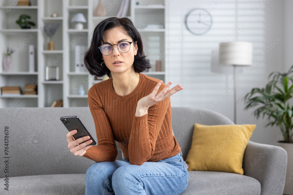 Confused woman receiving bad news via text message Stock Photo | Adobe ...