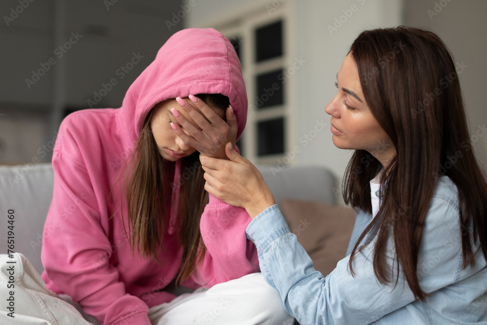 Worried mom comforting depressed crying teen daughter, mother supporting sad teenage girl having ...