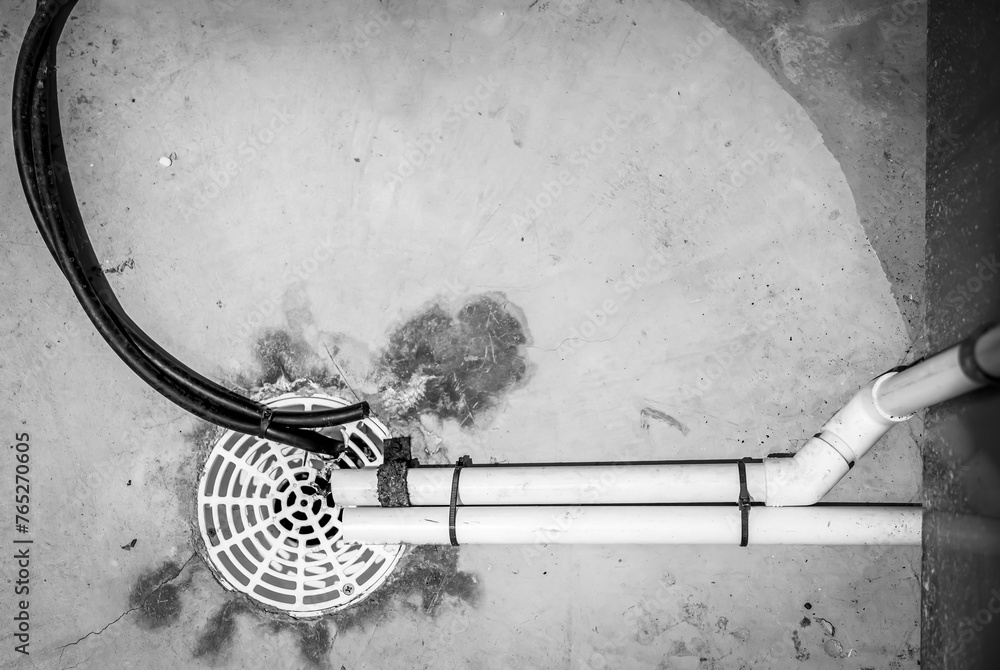 Selective focus on a residential house basement floor drain with ...
