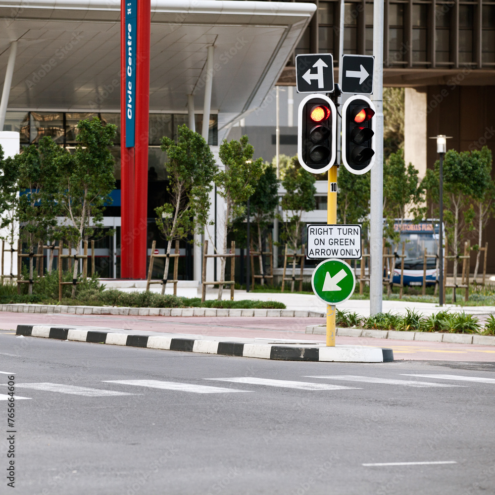 Road sign, traffic light and city with arrow for direction with travel ...