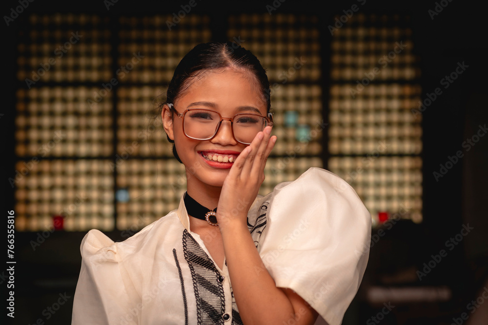 A young tour guide dressed in a traditional Baro't Saya welcomes ...