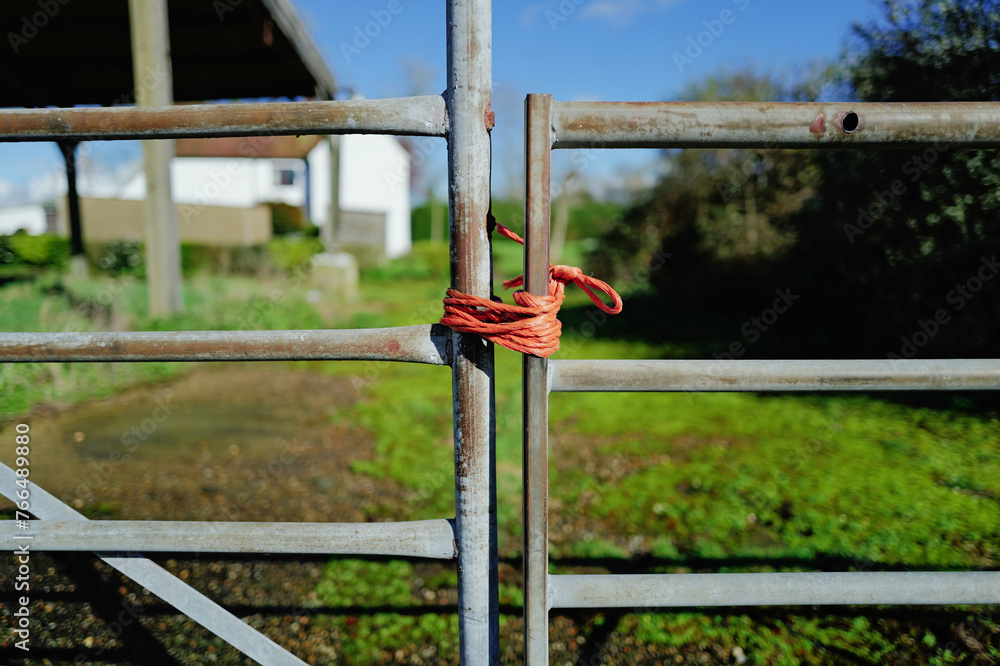 Impromptu bailing string seen tied to a pair of farm gates. The gates ...