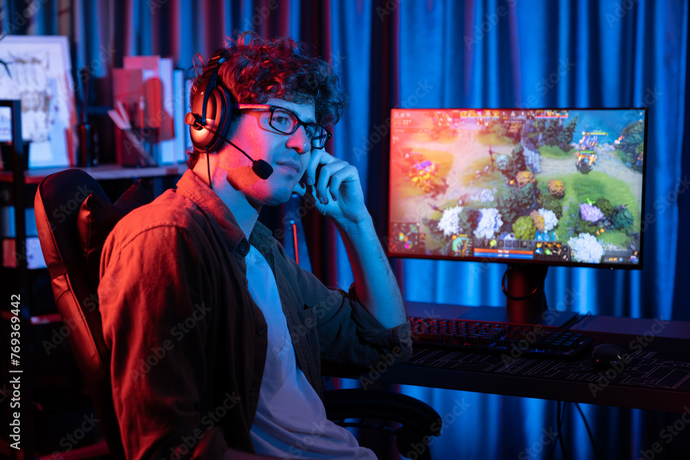 Host channel of young gaming streamer looking out from room, wearing ...