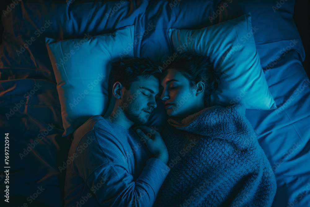 top view couple sleeping in bed at night. husband and wife cuddling ...
