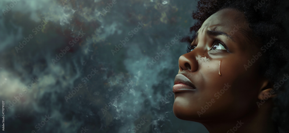 Young black woman looking up praying to God with tears in eyes, being ...