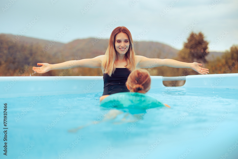 Loving Mother Teaching her Daughter how to Swim. Happy mom giving ...