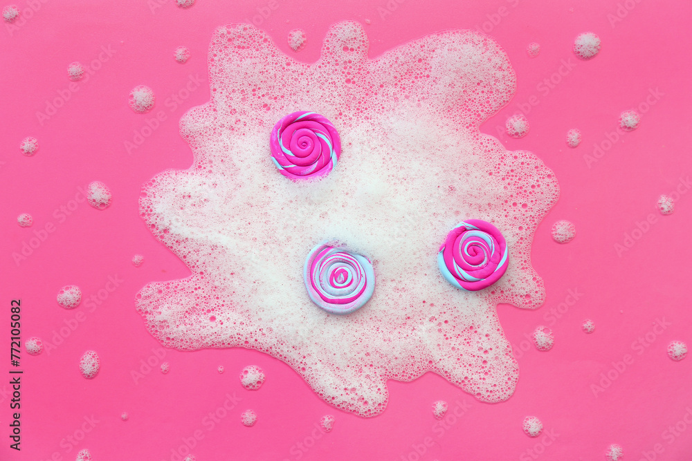 Soap in shape of candies in foam on pink background Stock Photo | Adobe ...