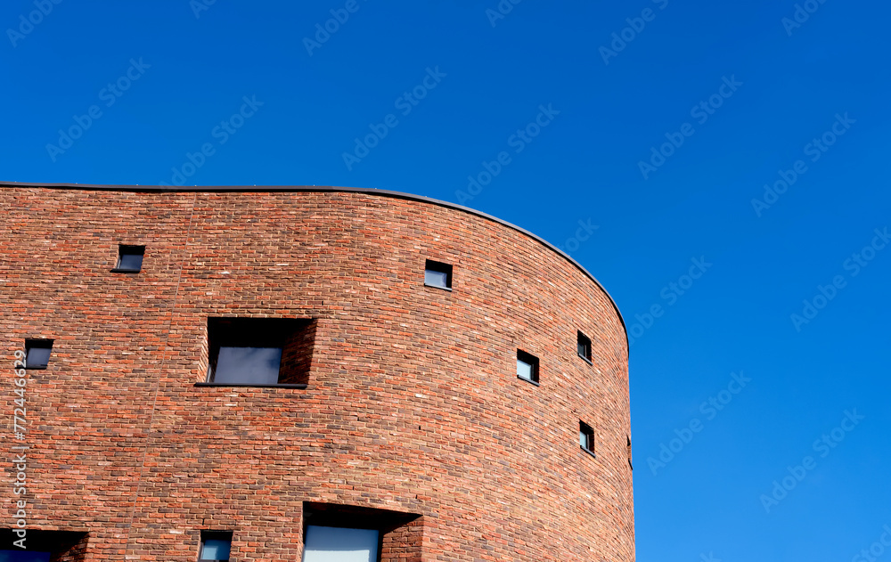 Foto de Stock Old City high rise with red bricks on blue sky background ...