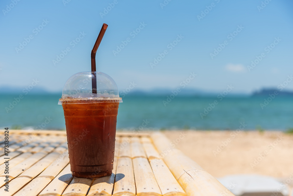 Ice black coffee and sea beach background, iced coffee americano in ...