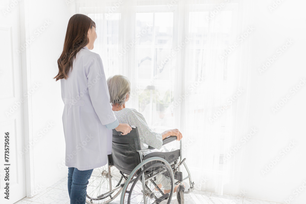 Asian doctor drive a wheelchair of old patient, doctor and old female ...
