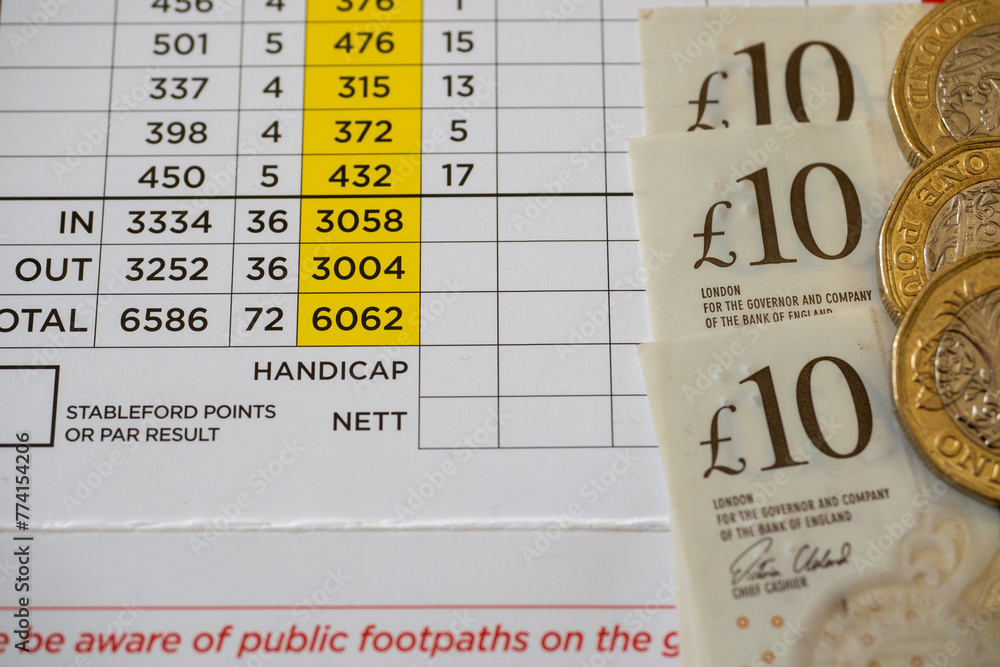 Close-up photograph of a Golf Course scorecard with cash in the form of ...