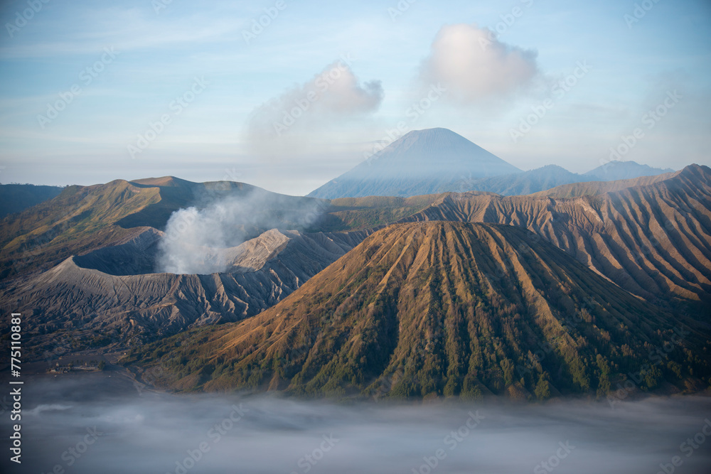 Mount Bromo with smoke, Mount Batok at front, and Mt Gunung Semeru at ...
