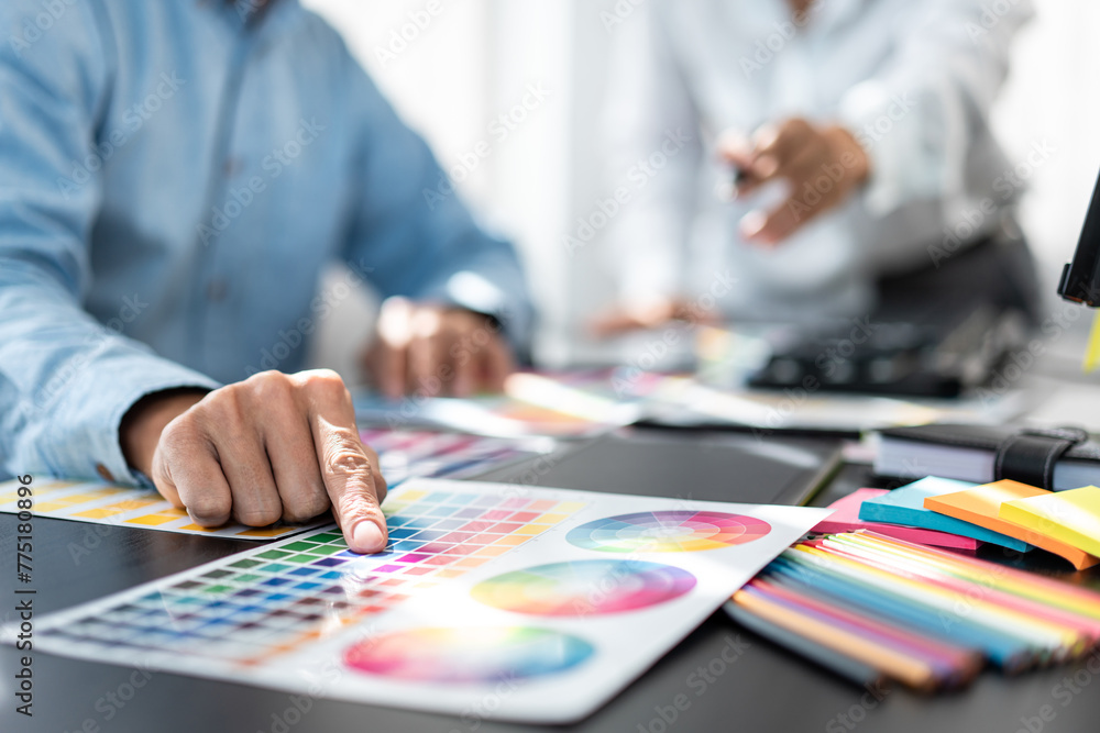 Team of creative graphic designer working on color swatch samples chart ...