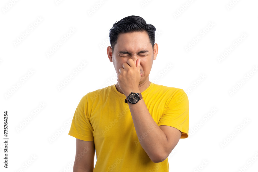 Handsome Asian man pinching his nose with fingers, smelling something ...