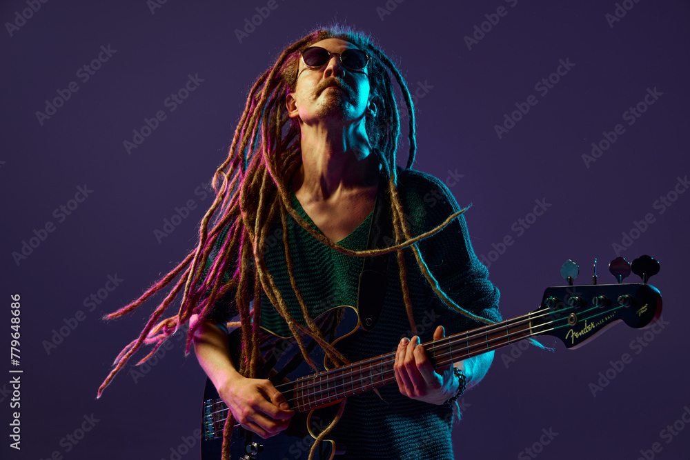 Captivating sight of man with dreadlocks, musician expressing his ...