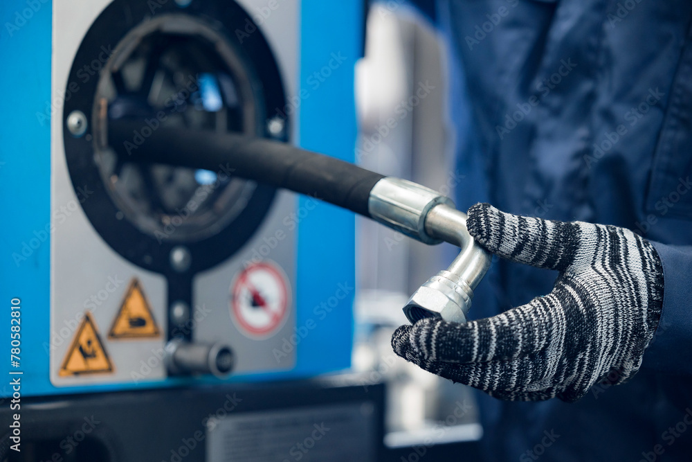 Manufacturing process Worker crimps pressure hydraulic hose with ...