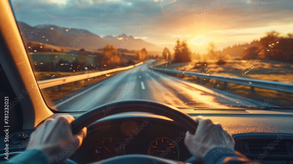 Driver's perspective on an open road journey towards a stunning sunset ...