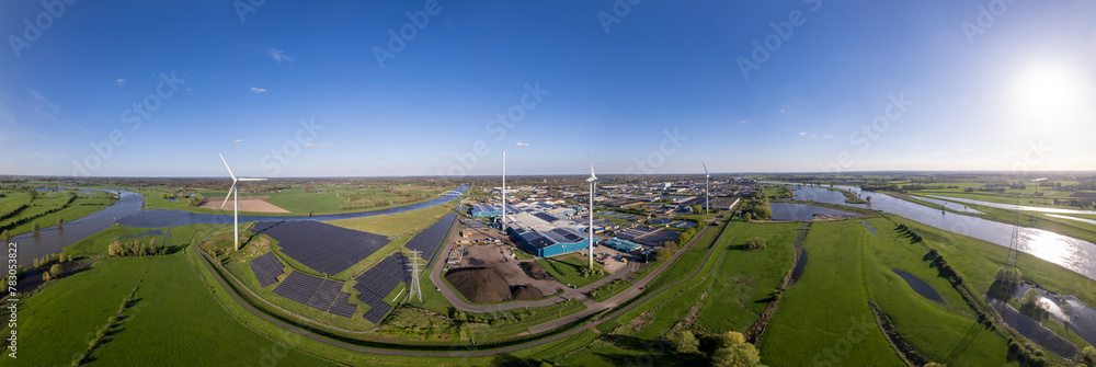 Dutch landscape panorama of wind turbine and solar panels with waterway ...