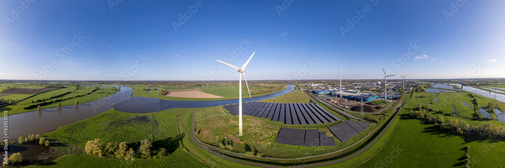 Dutch landscape panorama of wind turbine and solar panels with waterway ...