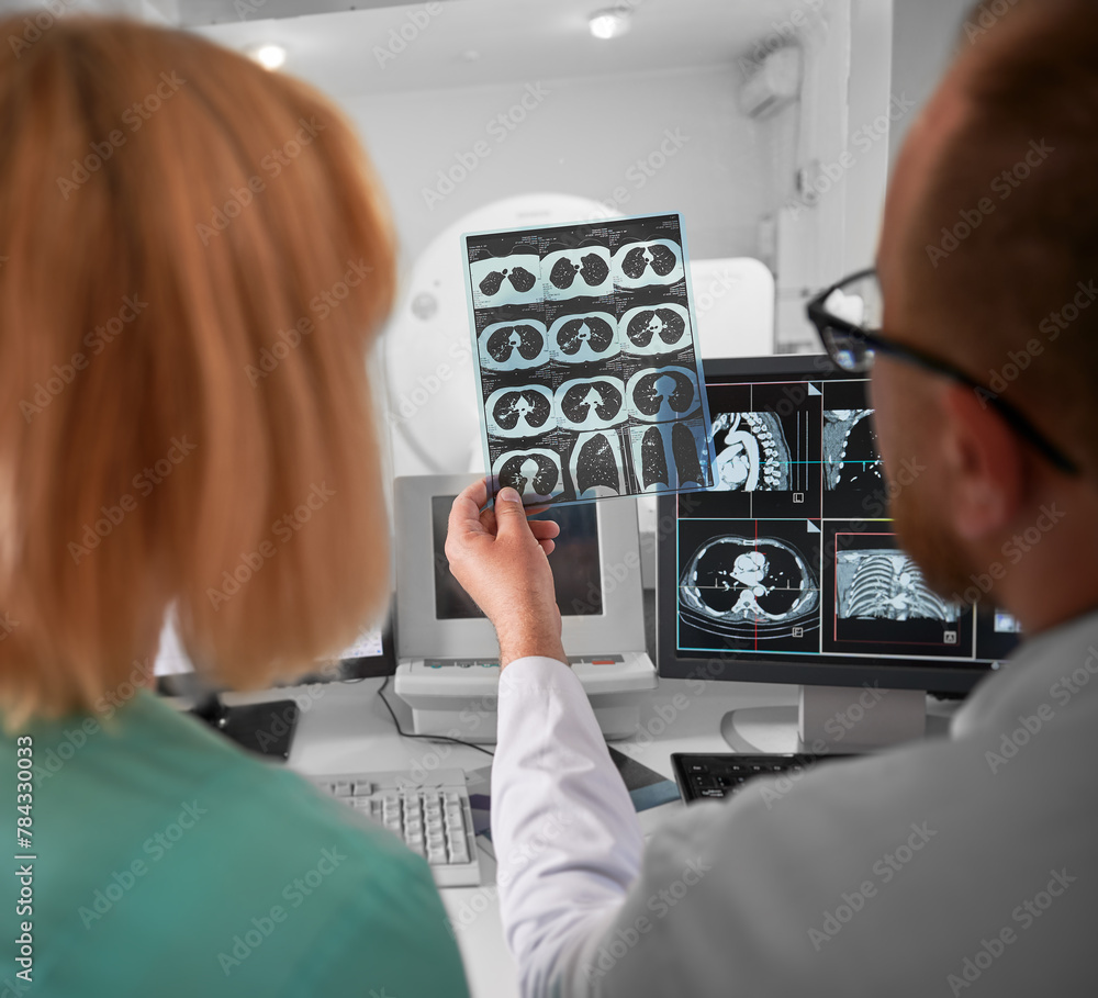Medical computed tomography or MRI scanner. Back view of doctor and ...