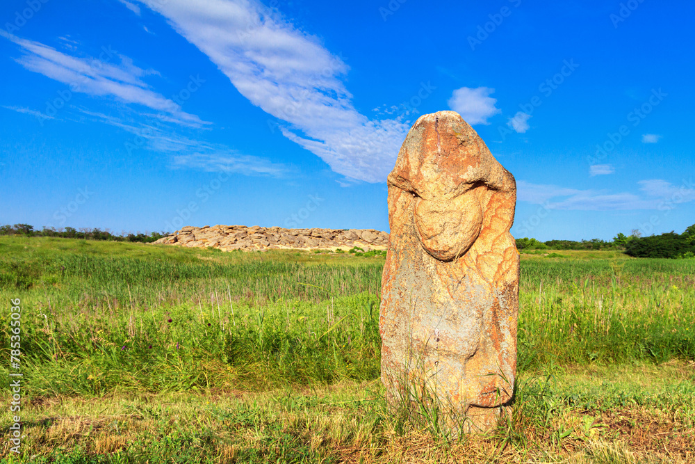 View of the ancient kurgan stela, stone idol against the backdrop of ...