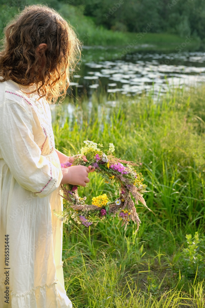 girl with flower wreath outdoor, natural sunny background. rear view ...
