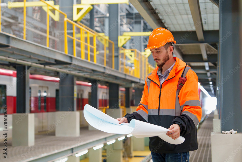 Electrical engineer railway in the maintenance station using blueprint ...