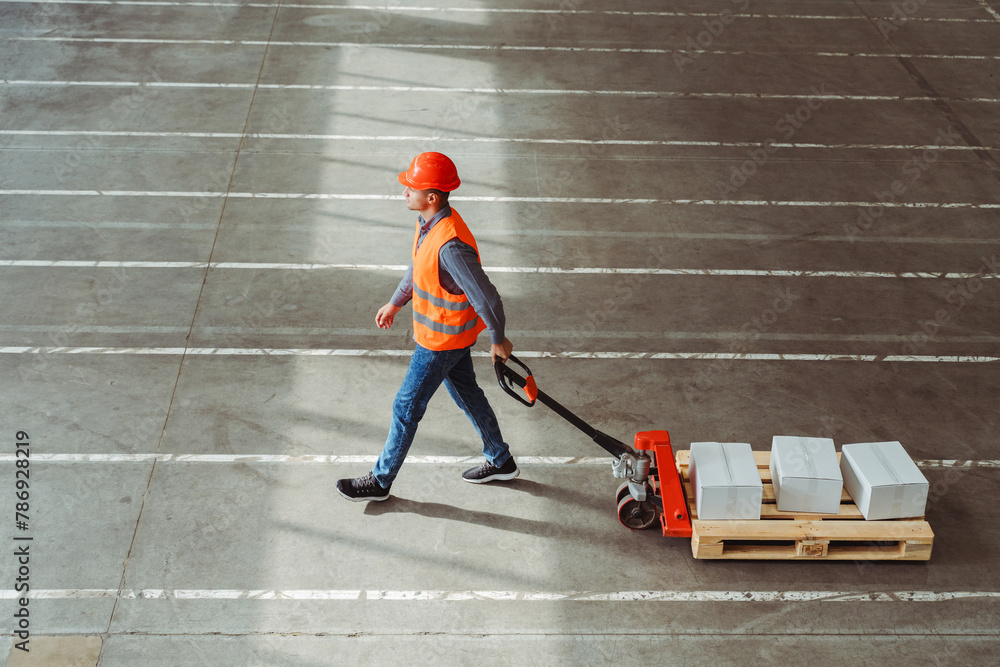 Factory worker, engineer wearing hard hat, vest, work clothes carrying ...
