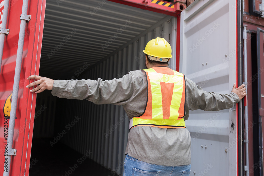 Male container yard worker open containers box at commercial dock site ...