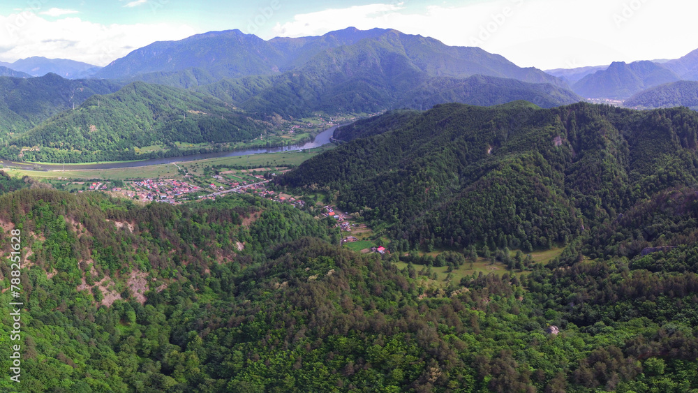Aerial drone view above Olt valley and a small village located deep ...