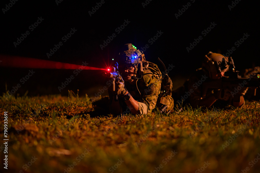 Soldiers in camouflage uniforms aiming with their rifles.ready to fire ...