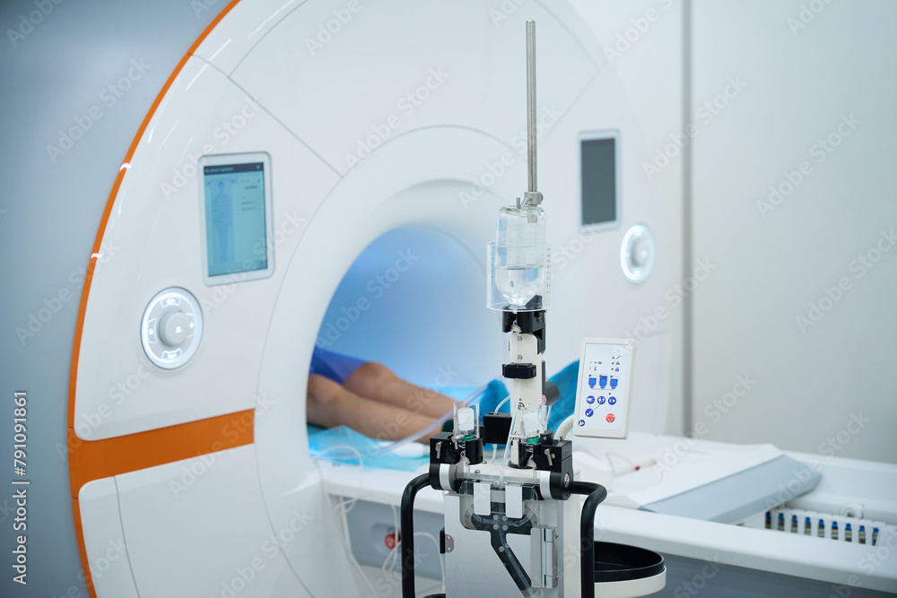 Clinic client undergoing contrast-enhanced magnetic resonance imaging ...
