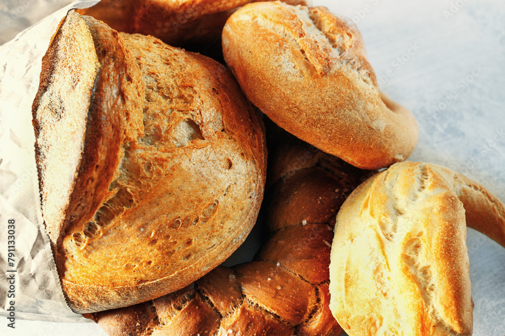 Assortment of bakery products. Challah, braided bread ring, kalachi ...
