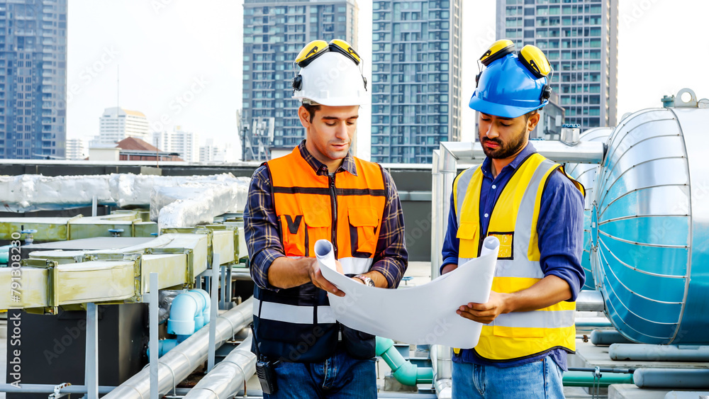 Contractor, Two civil engineers checking information from blueprint ...