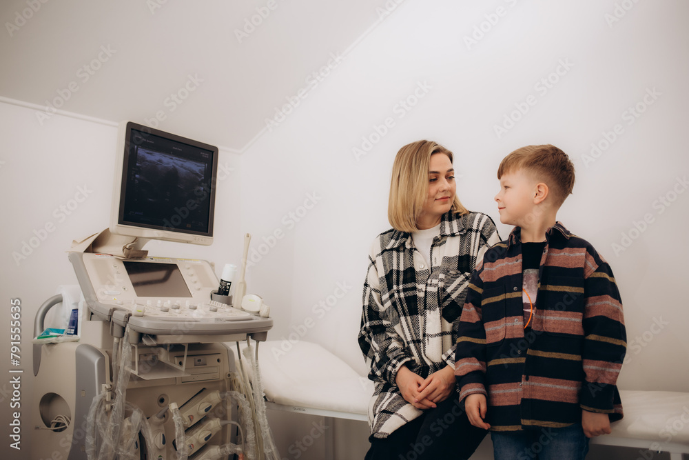 Doctor making ultrasonography to male child patient at ultrasound ...