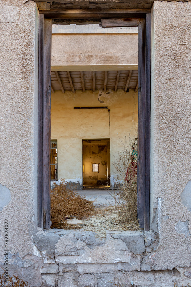 Symmetrical tunnel of door frames in abandoned buildings in Al Jazirah ...