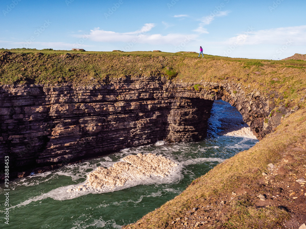 Tourist enjoy stunning Bridges of Ross in county Clare, Ireland. Rock ...