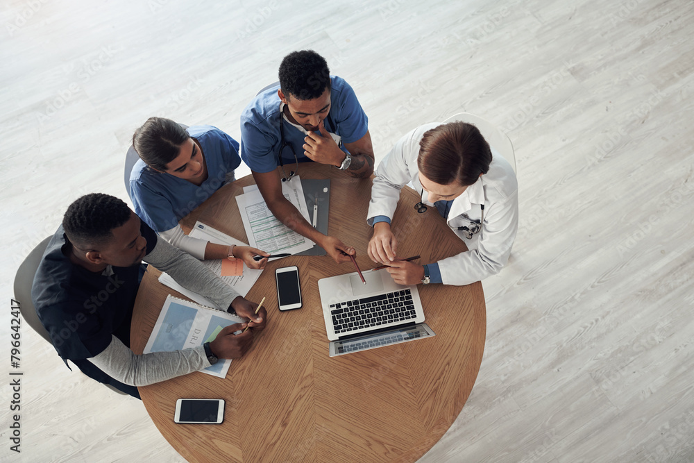 Doctor, teamwork and planning in meeting with computer, documents and ...