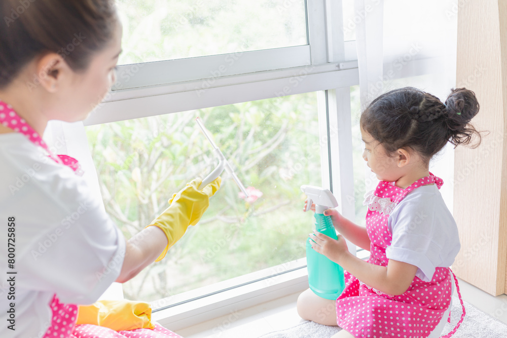 Asian children learning to clean bedroom with her mother, they wipe ...