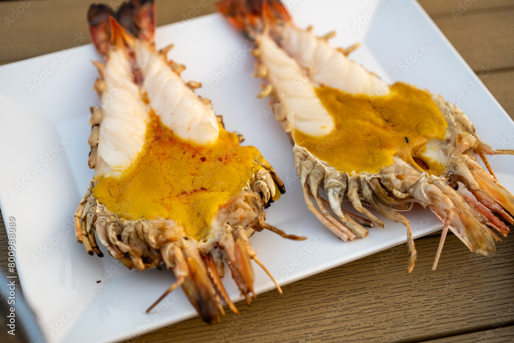 Large river prawns are grilled and cut in half to reveal the meat and ...