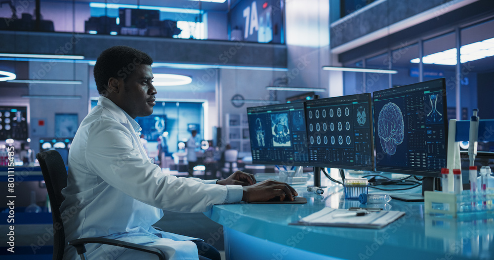 Black Male Neuroscientist Using Desktop Computer To Analyze MRI Scans ...