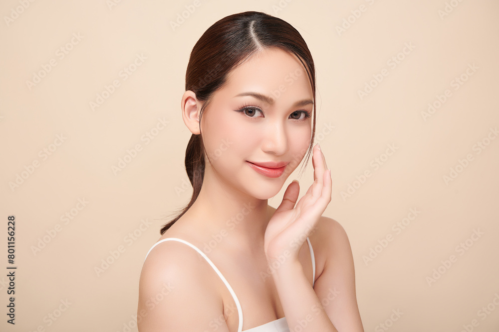 Beautiful young asian woman with clean fresh skin on beige background ...