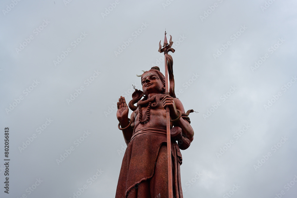 Red Lord Shiva Statue with Trident in Ganga Talao or Grand Bassin ...