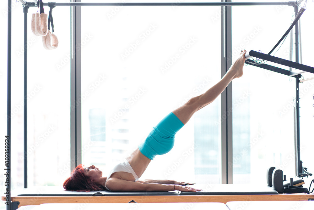 Beautiful woman performing pilates over white background with reverse ...